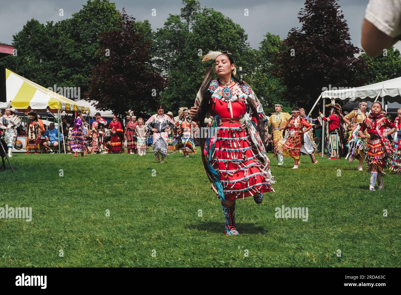 Une jeune fille amérindienne en tenue de châle dansant au pow wow un ... Une jeune fille amérindienne en tenue de châle dansant au pow wow un ...
