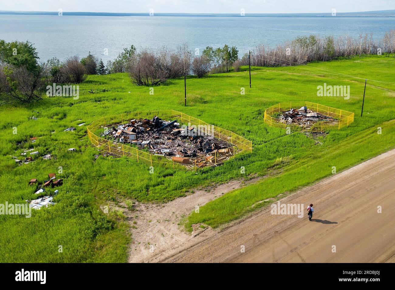 Yellow fencing surrounds two buildings destroyed by a May wildfire at ...