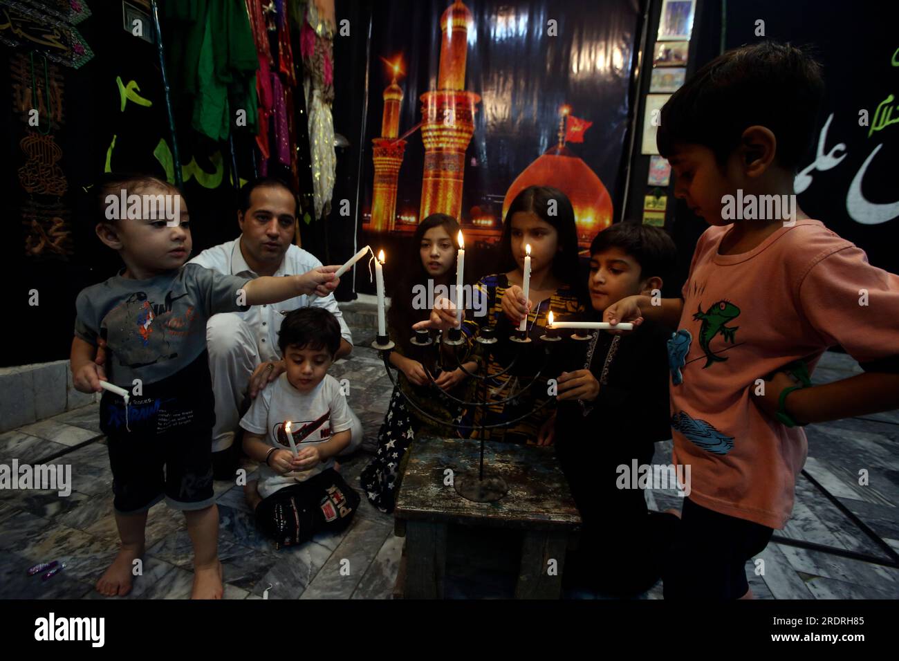 People participate and light candles in the Ashoura procession at Imam ...