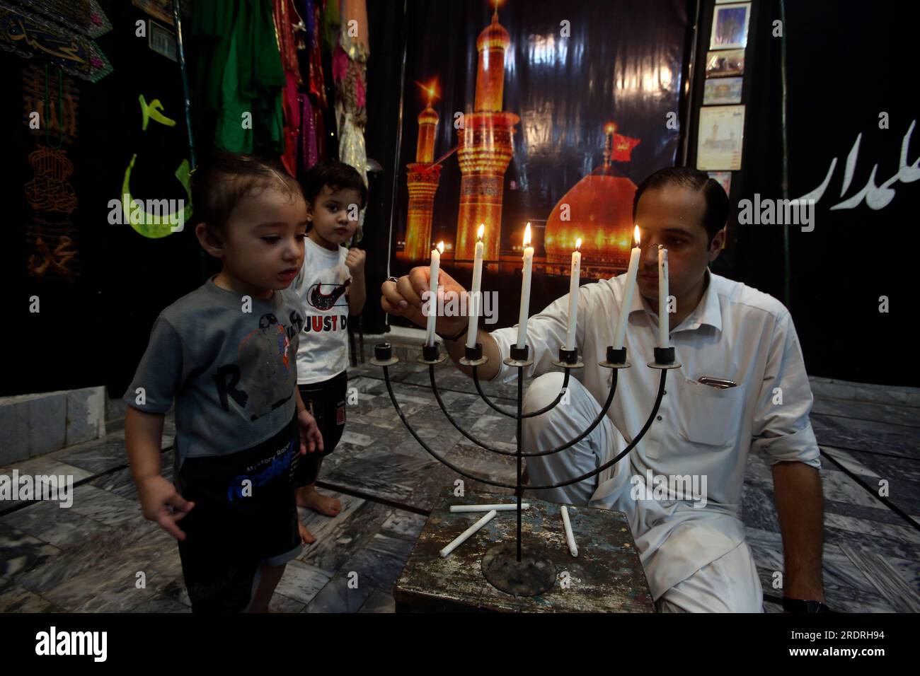 People participate and light candles in the Ashoura procession at Imam ...