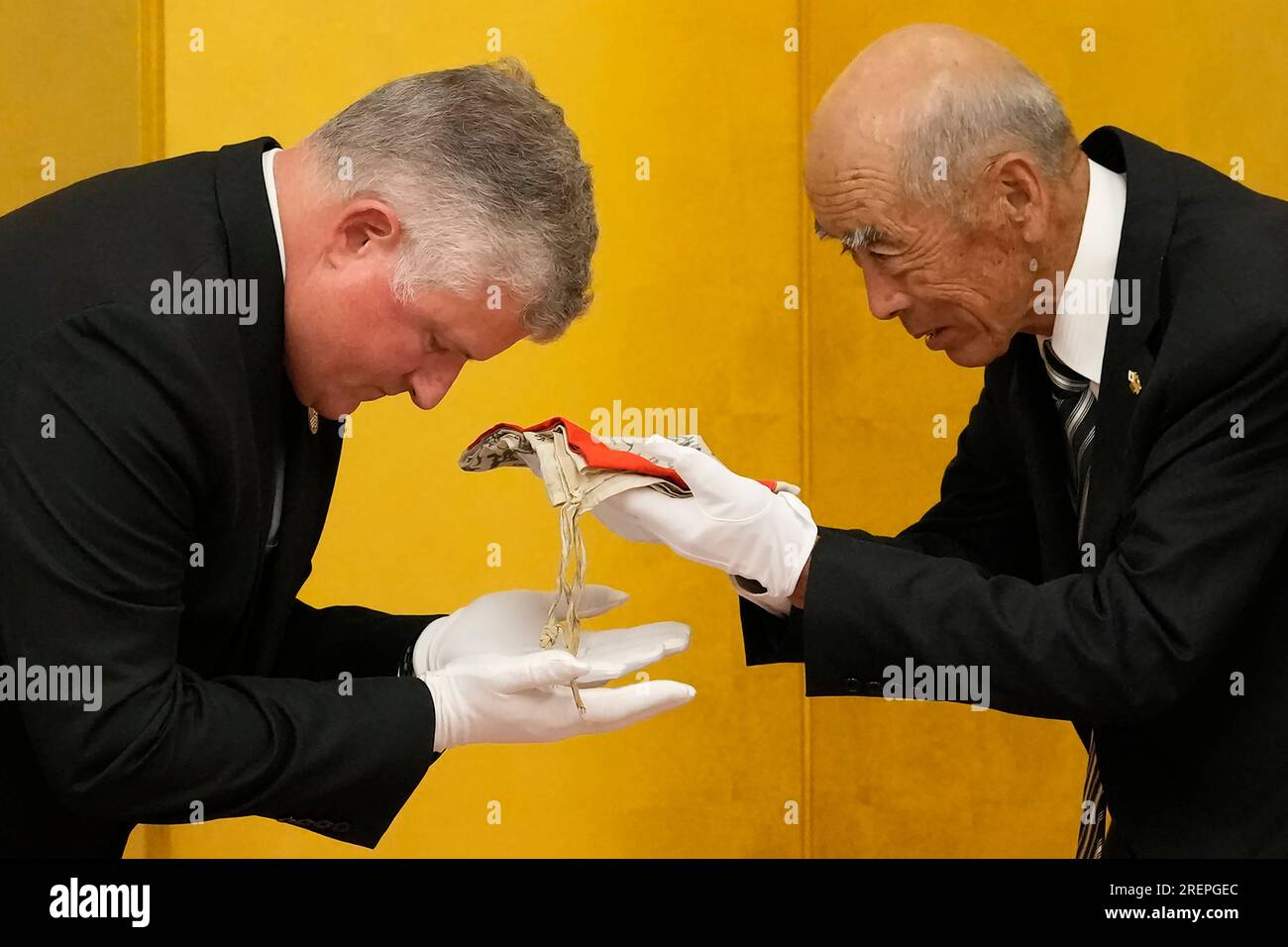 USS Lexington Museum executive director Steve Banta, left, hands over ...