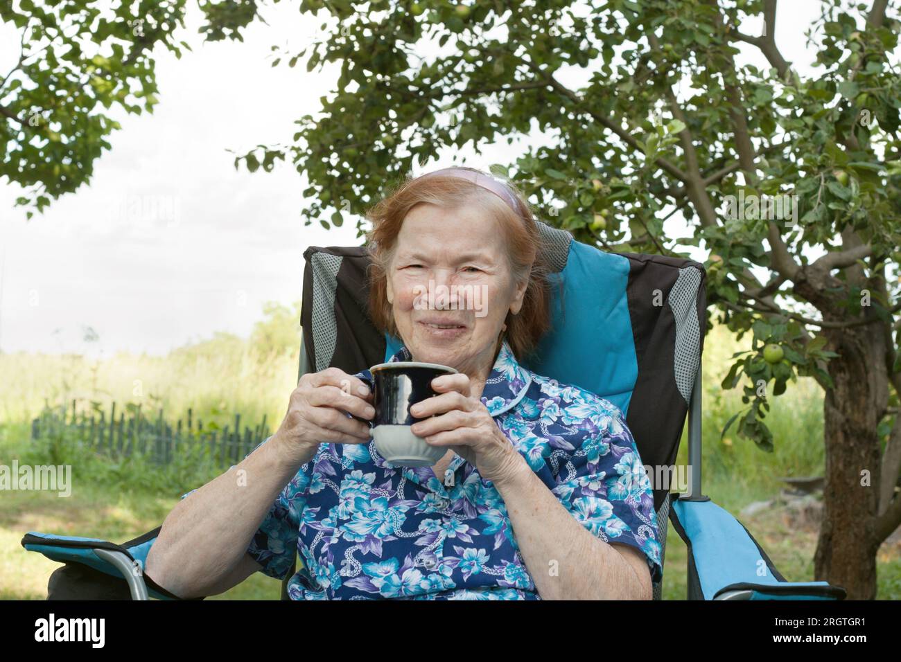 Portrait de grand-mère aînée souriante heureuse dans le jardin à la ...