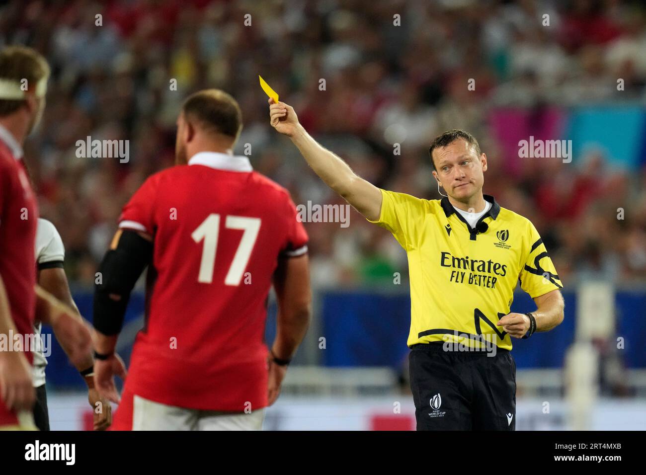Referee Matthew Carley, right, shows a yellow card to Wales' Corey ...