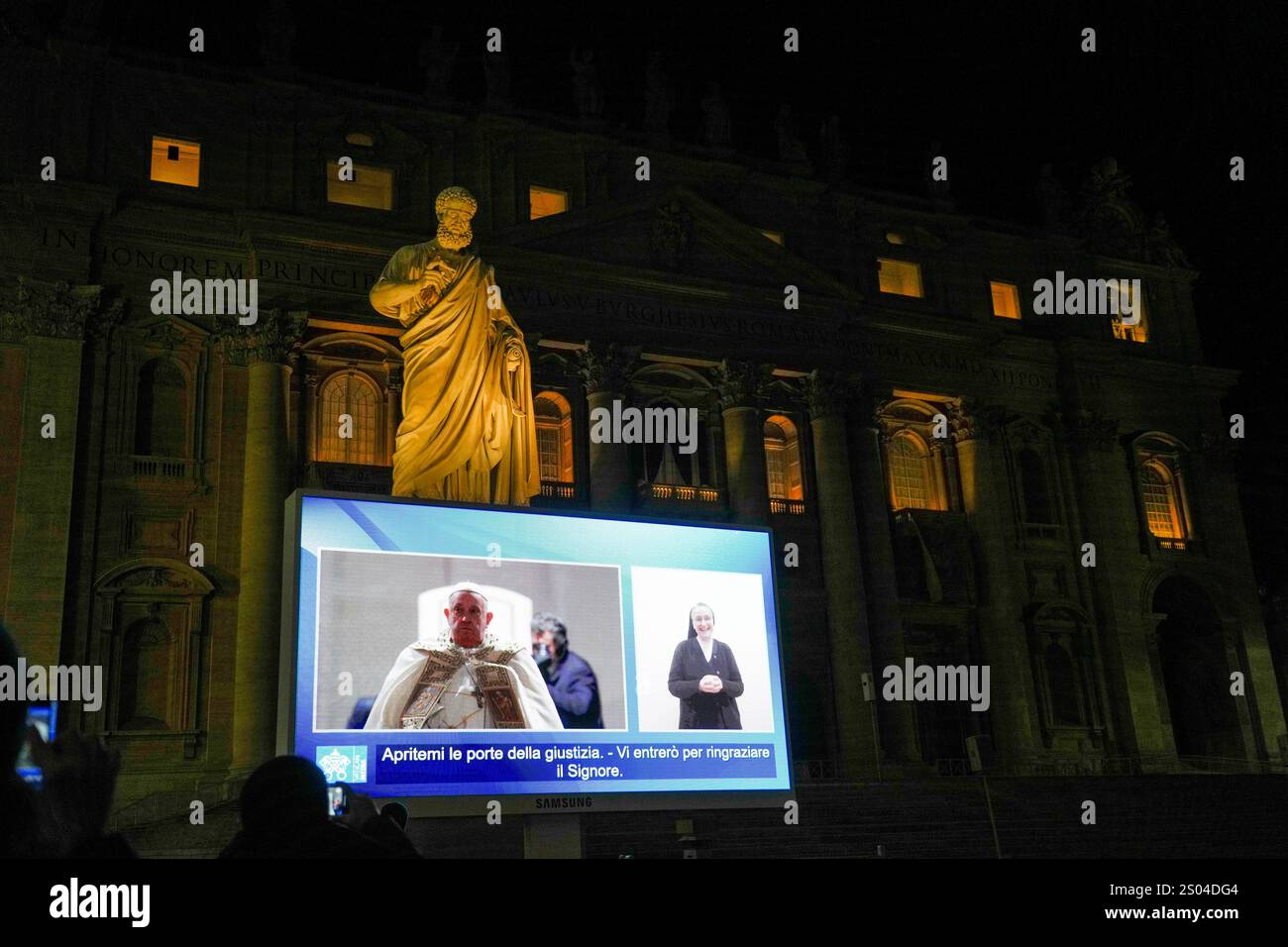 A giant monitor in St. Peter's Square shows Pope Francis pausing before ...
