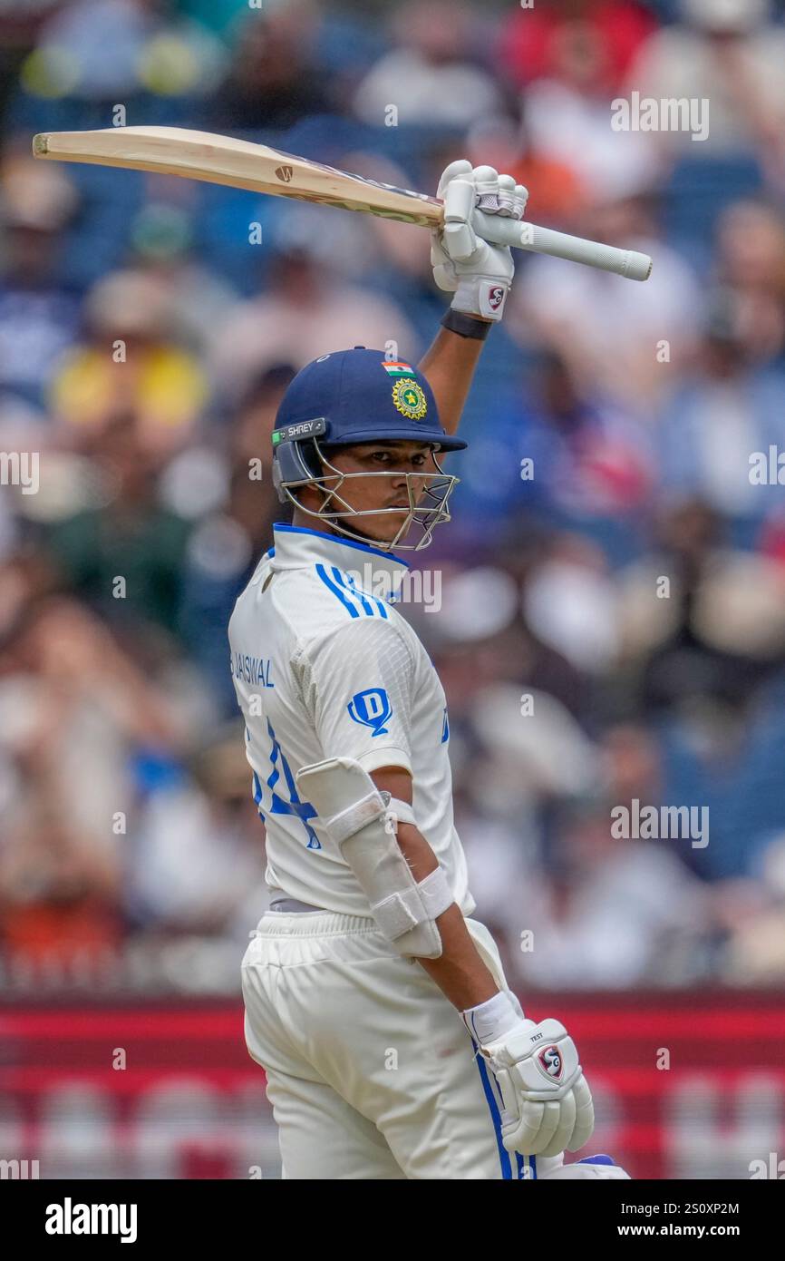 India's Yashasvi Jaiswal raises his bat as he celebrates after scoring ...