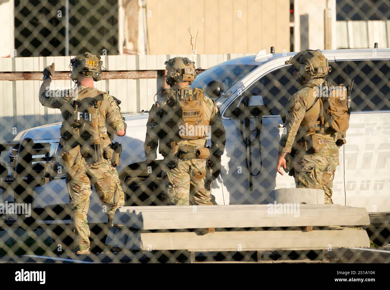 FBI and Harris County Sheriff's SWAT members are shown near Crescent ...