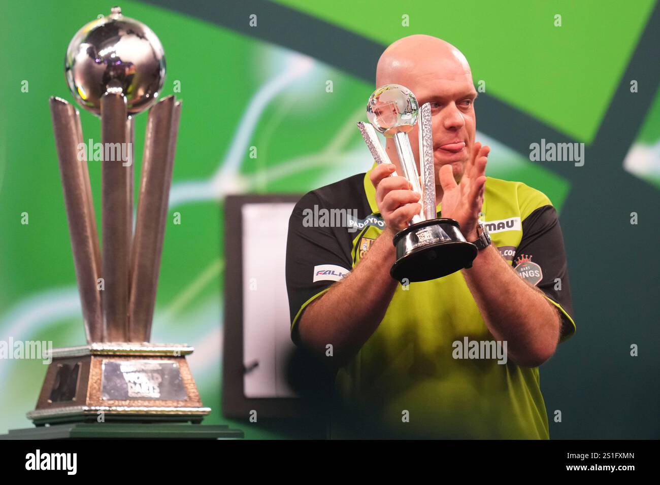 Michael van Gerwen of the Netherlands, holding the runner-up trophy ...
