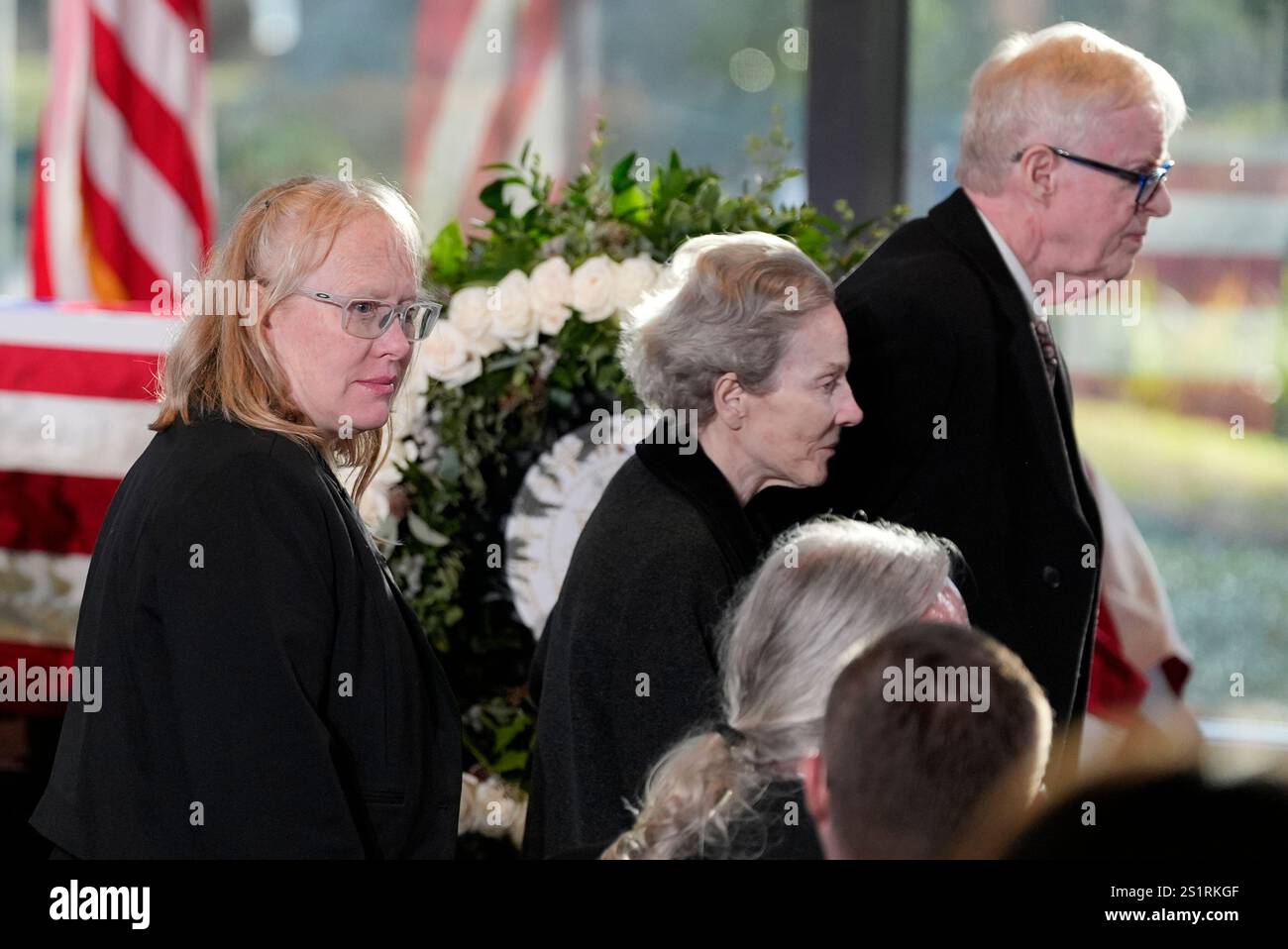 Amy Carter, left, and other family members, depart after a service for ...