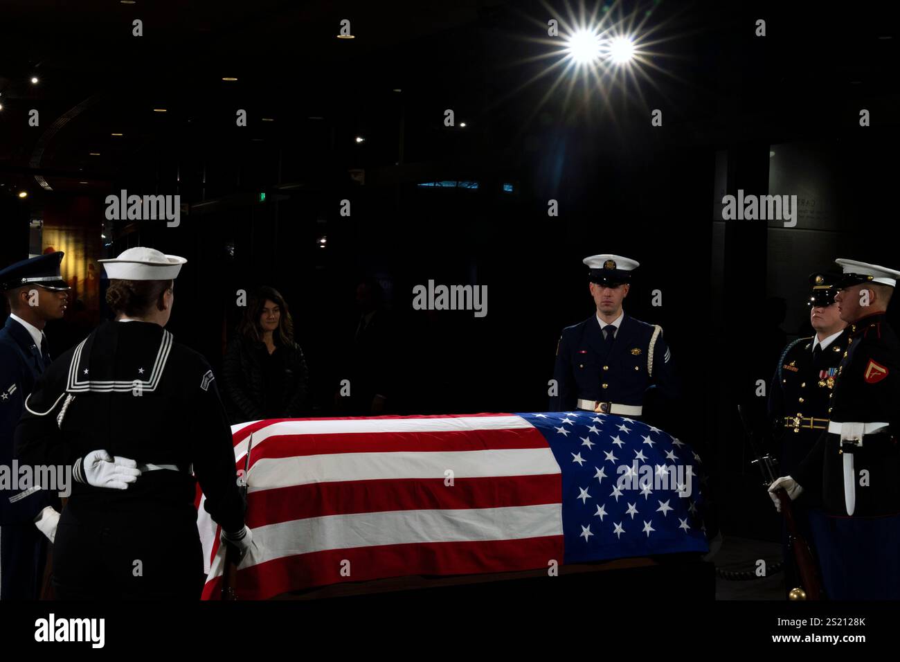 Mourners view the casket of former President Jimmy Carter as he lies in ...