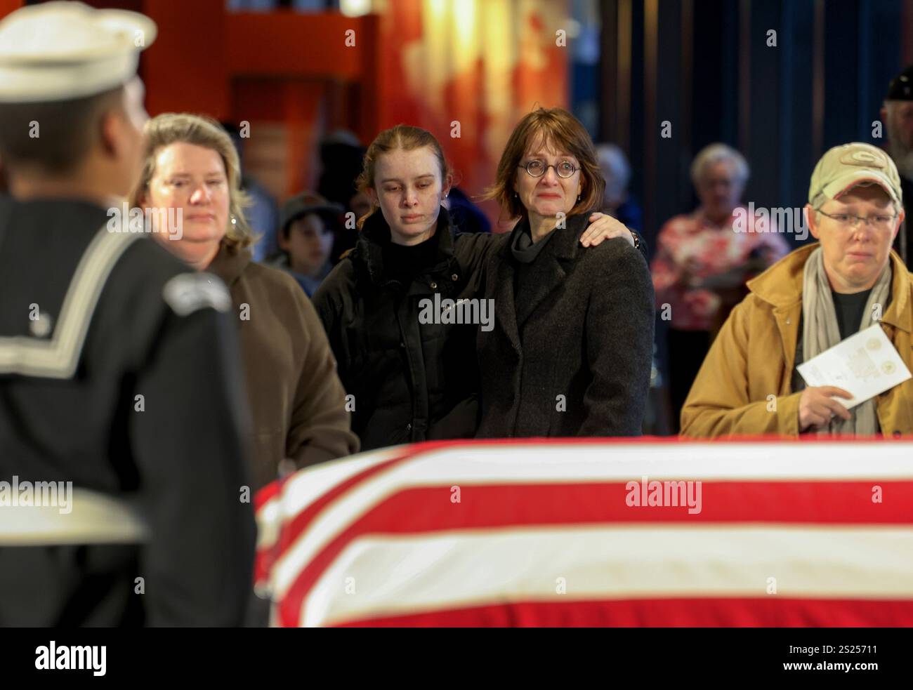 Members of the joint services military honor guard stand by the casket bearing the remains of ...