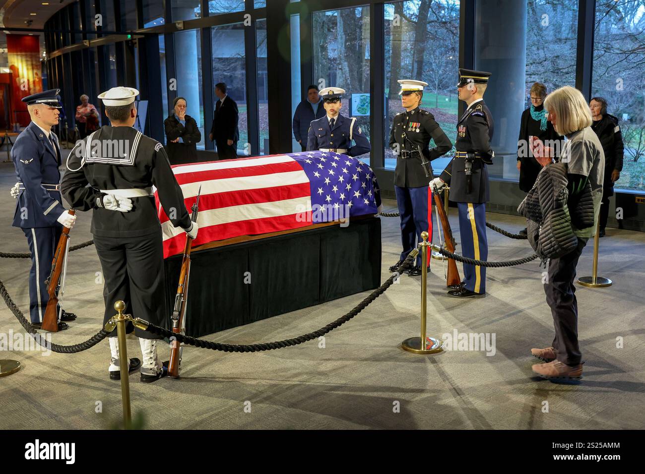 Members of the joint services military honor guard stand by the casket bearing the remains of ...