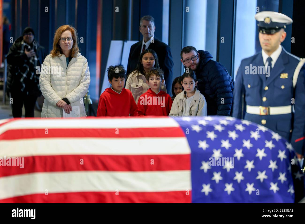 Members of the joint services military honor guard stand by the casket bearing the remains of ...