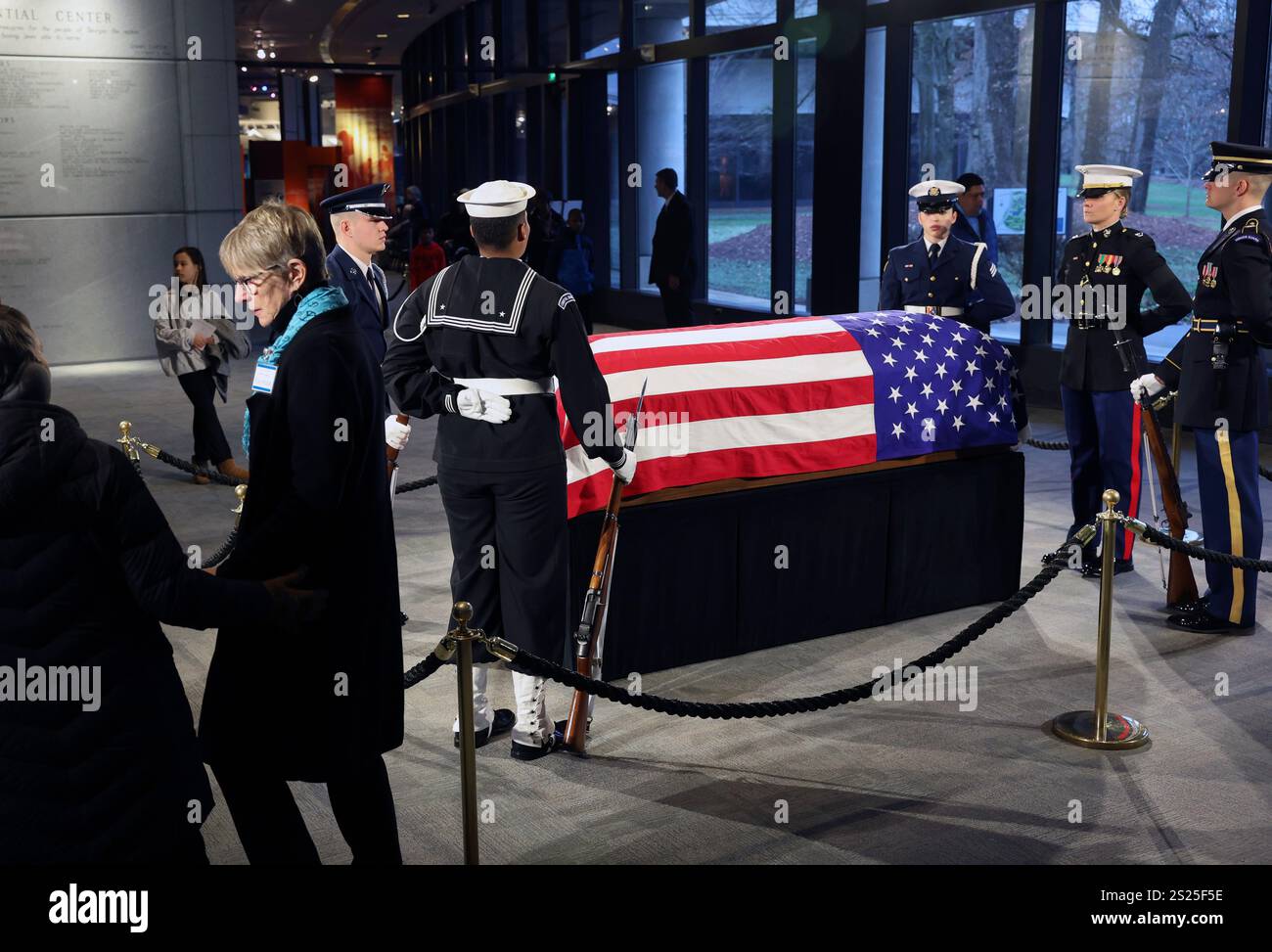 Members of the joint services military honor guard stand by the casket bearing the remains of ...
