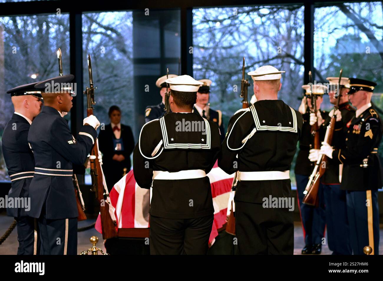 The guard of honor changes as mourners view the casket of former President Jimmy Carter as he ...