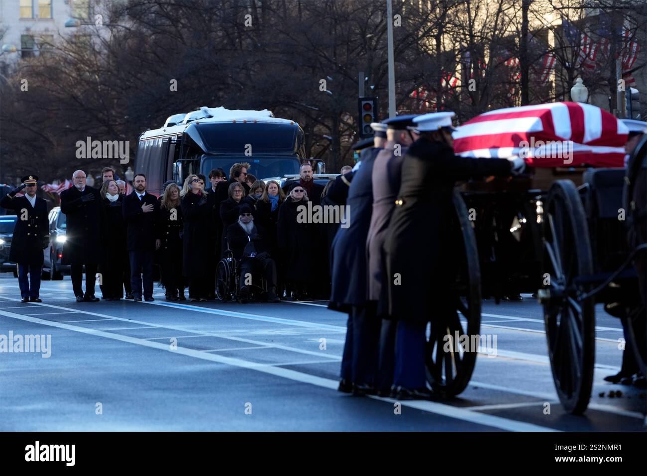 Family members watch as the casket containing the remains of former ...