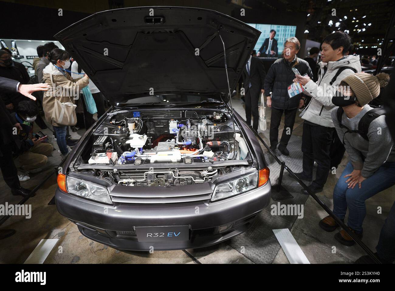 Visitors look at a Nissan R32 GT-R EV conversion, converted R32 Skyline GT-R into an EV, at the ...
