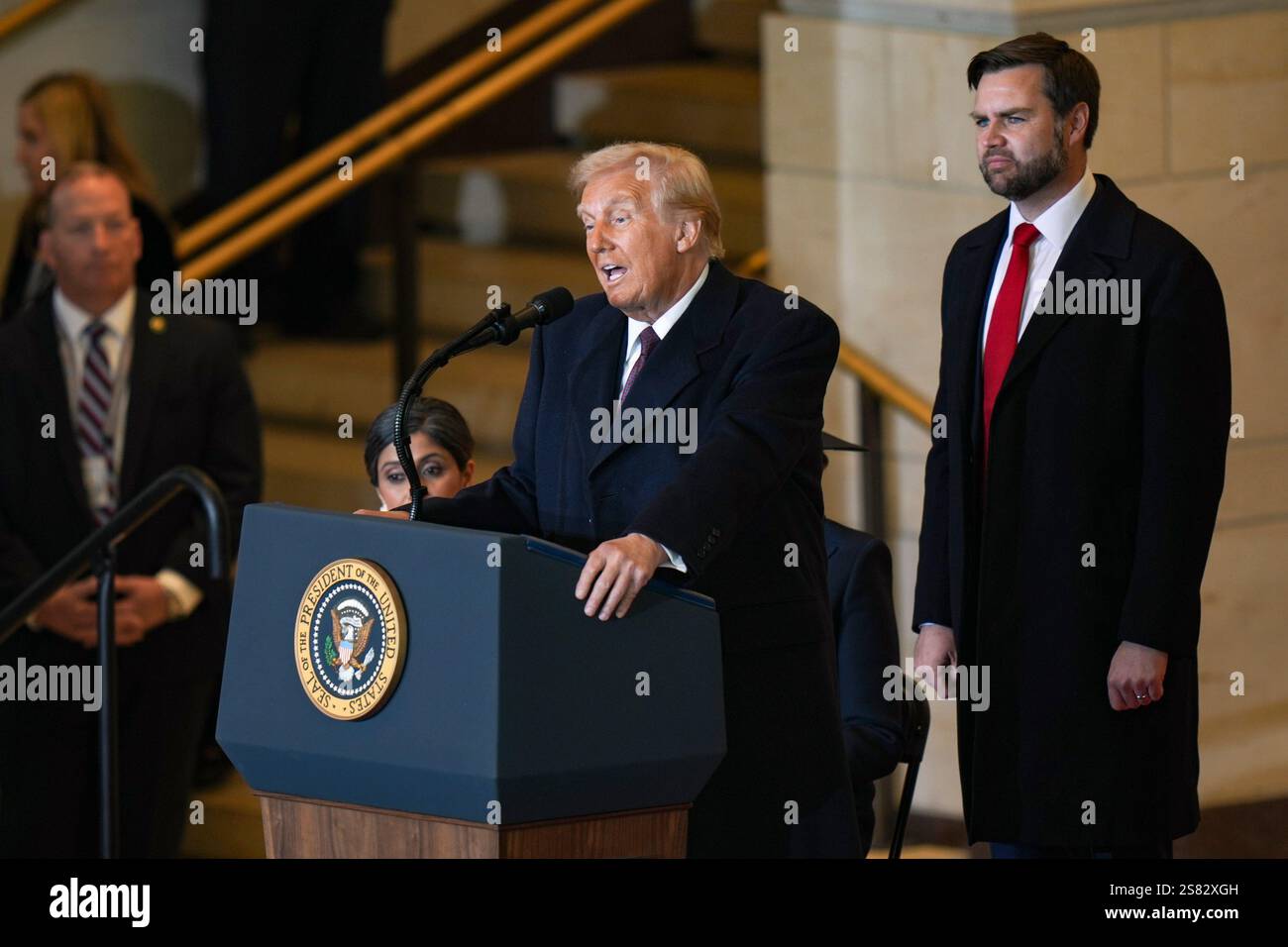 President Donald Trump speaks as Vice President JD Vance listens in ...