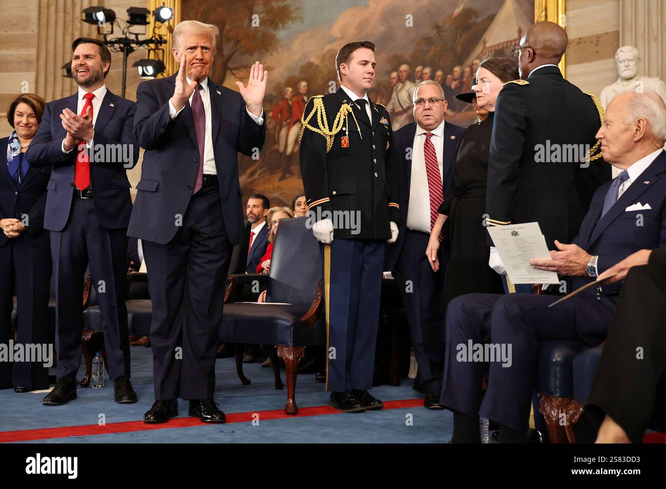 President Donald Trump gestures as Vice President JD Vance looks on ...
