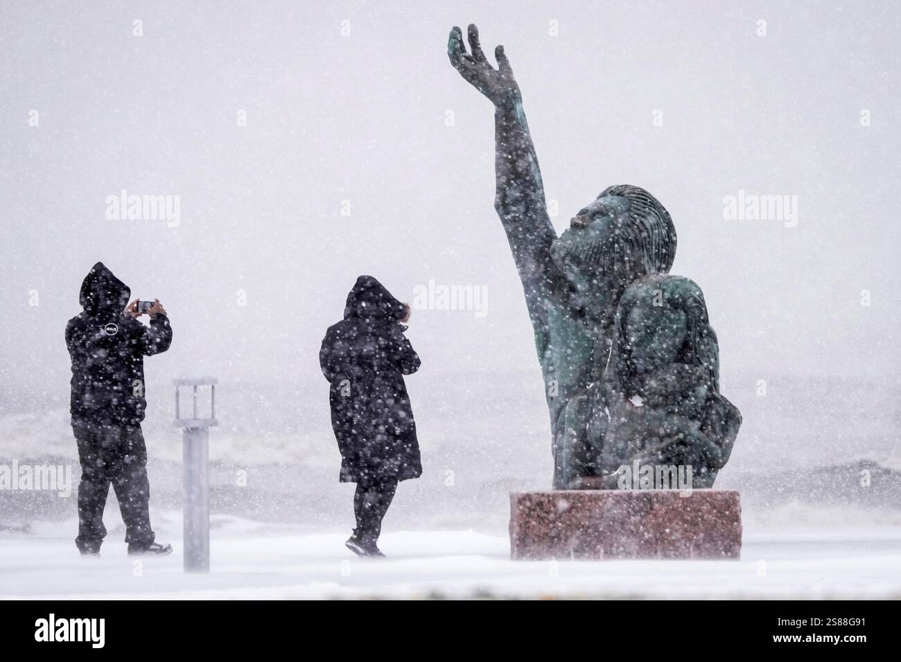 People take photos of the 1900 Storm memorial sculpture on Seawall Blvd ...