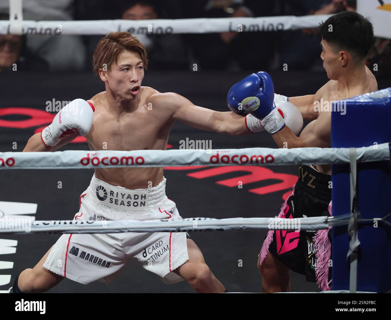 Naoya Inoue of Japan throws a punch against Ye Joon Kim of South Korea (R) during four ...