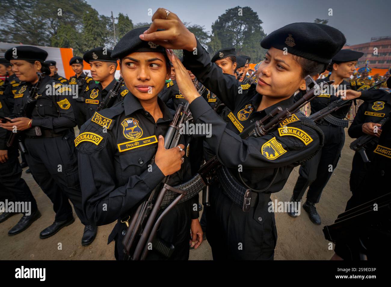An Assam police woman commando adjusts a cap for another commando ...