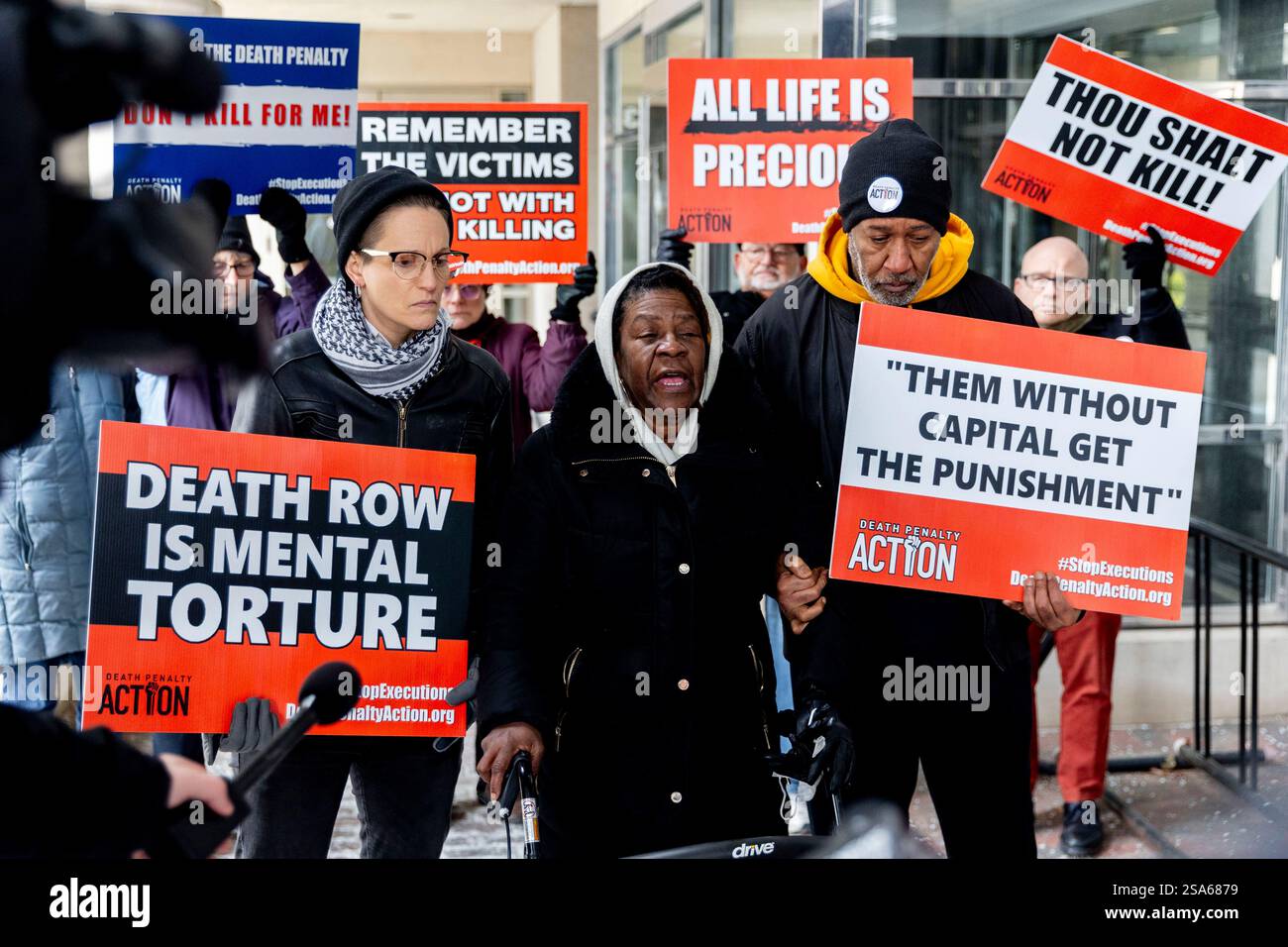 Lizz Schallert, left, and Charles Keith, right, stand in solidarity ...