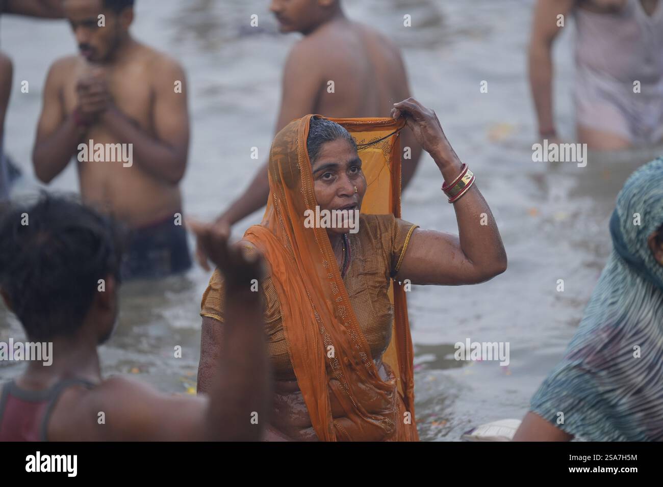 Hindu devotees take a holy dip by the banks of the Sangam, the ...
