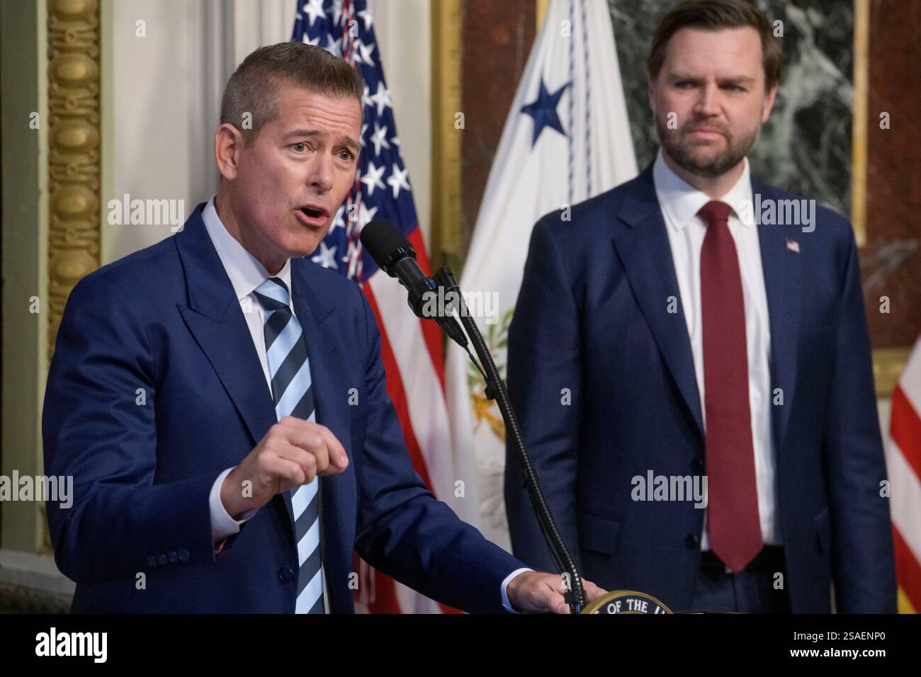 Transportation Secretary Sean Duffy, left, speaks after being sworn in ...