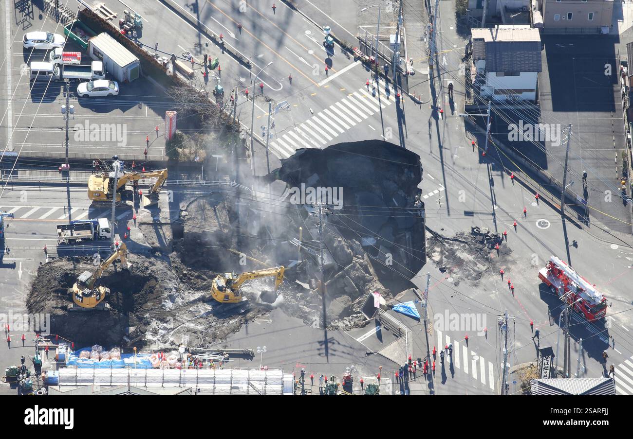 An aerial photo shows sinkholes at an intersection in Yashio City ...