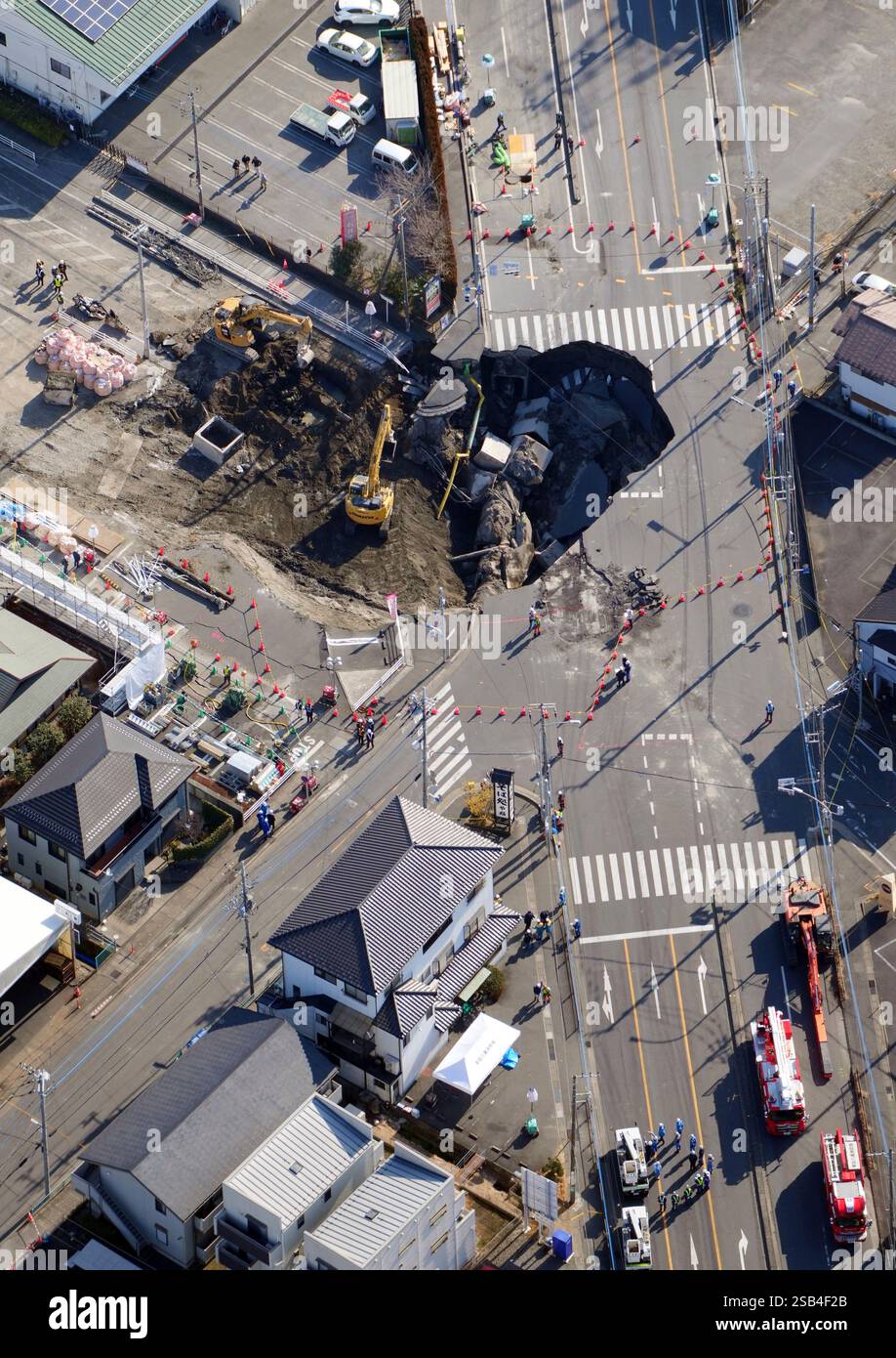An aerial photo shows sinkholes at an intersection in Yashio City ...