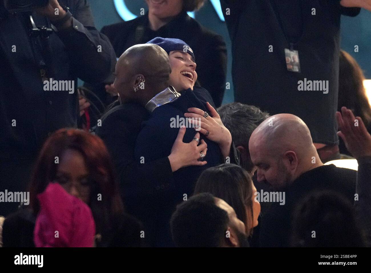 Billie Eilish, left, and Cynthia Erivo embrace in the audience during the 67th annual Grammy ...