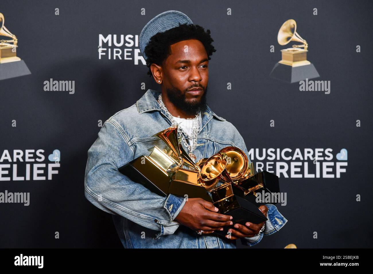 Kendrick Lamar poses in the press room with the award for record of the ...