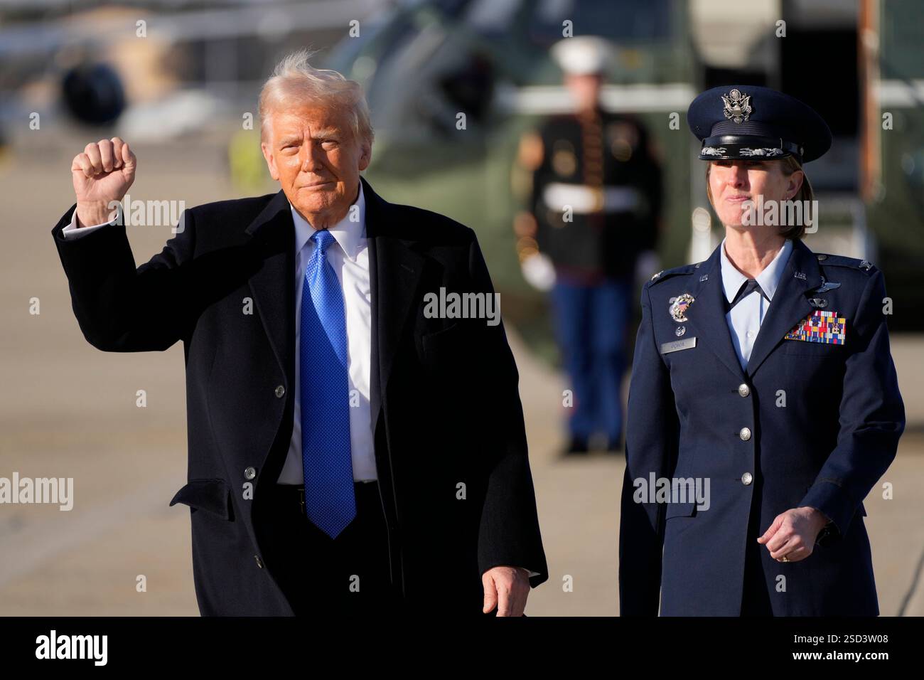 President Donald Trump gestures as he walks to board Air Force One with ...