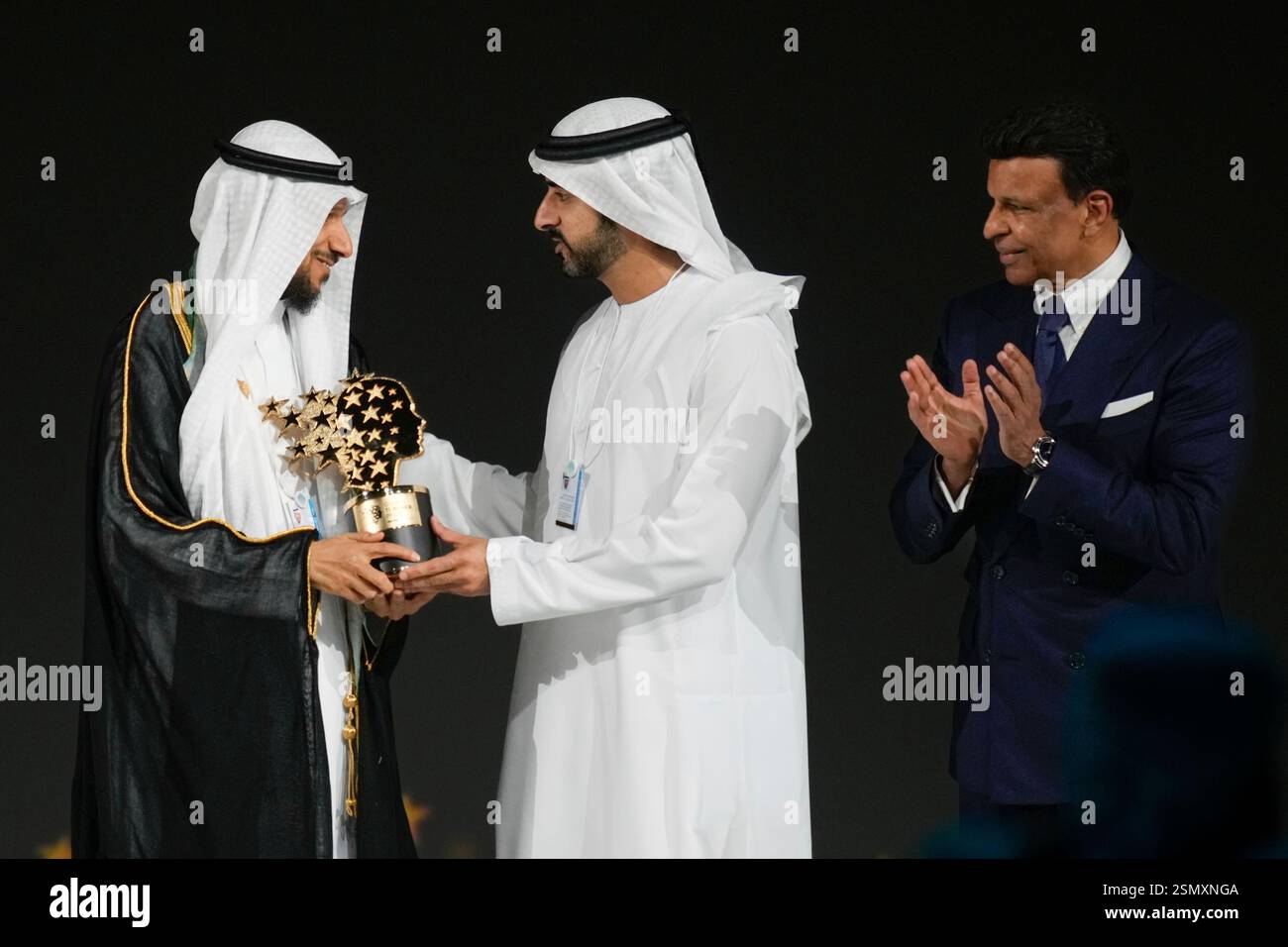 Saudi Arabian teacher Mansour bin Abdullah Al-Mansour, left, receives the Global Teacher Prize ...
