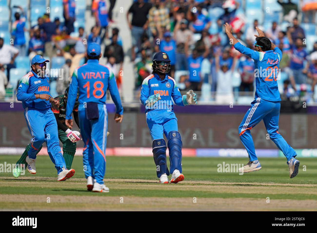 India's Axar Patel, right, celebrates with teammates after the ...
