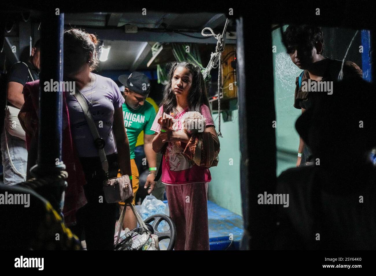 Venezuelan migrant Davinny Moreno boards a boat with her mother Eva ...