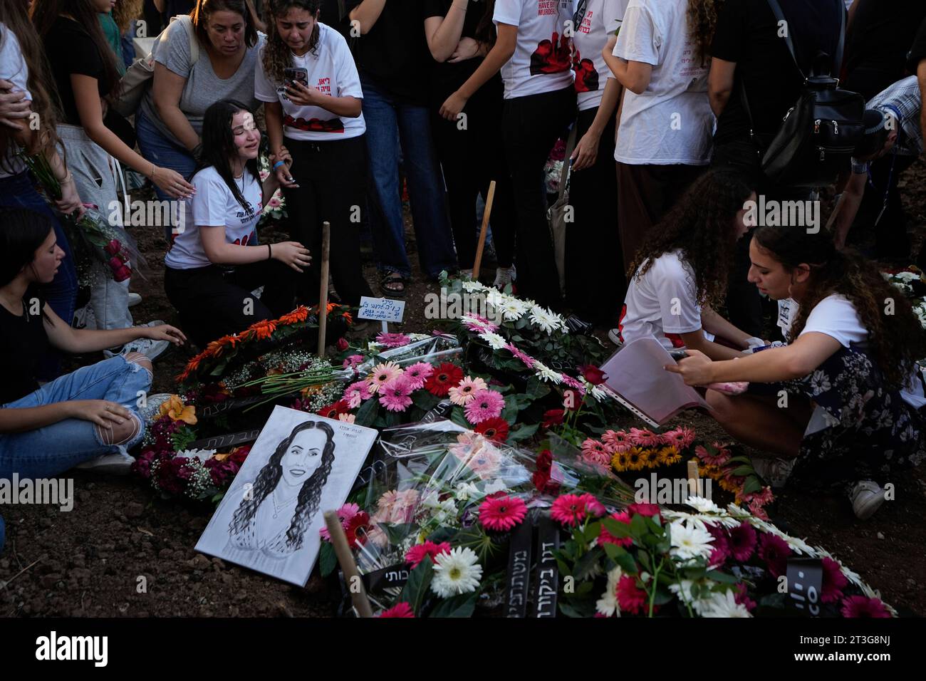 Mourners gather around the graves of British-Israelis Lianne Sharabi ...