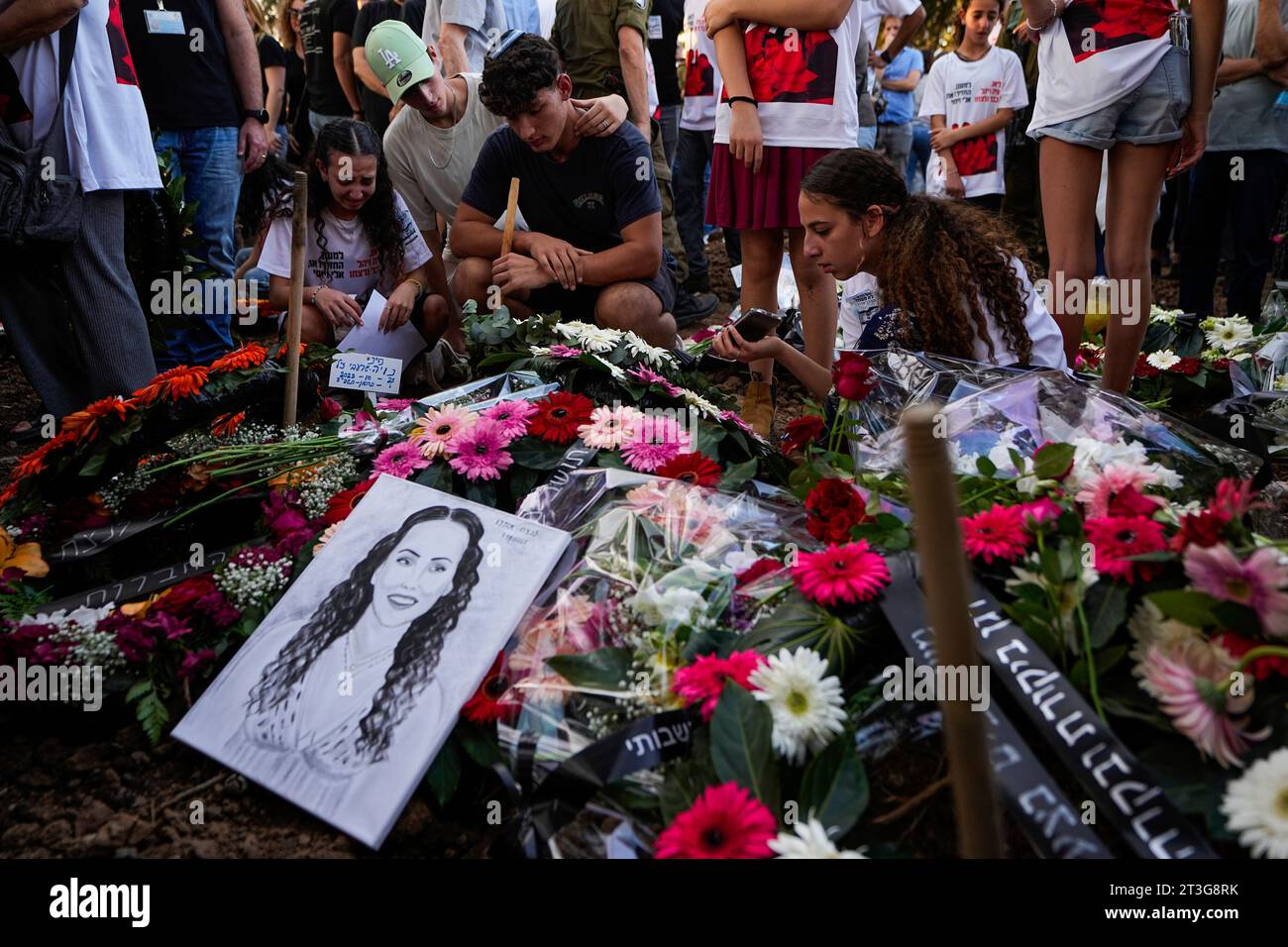 Mourners gather around the graves of British-Israelis Lianne Sharabi ...
