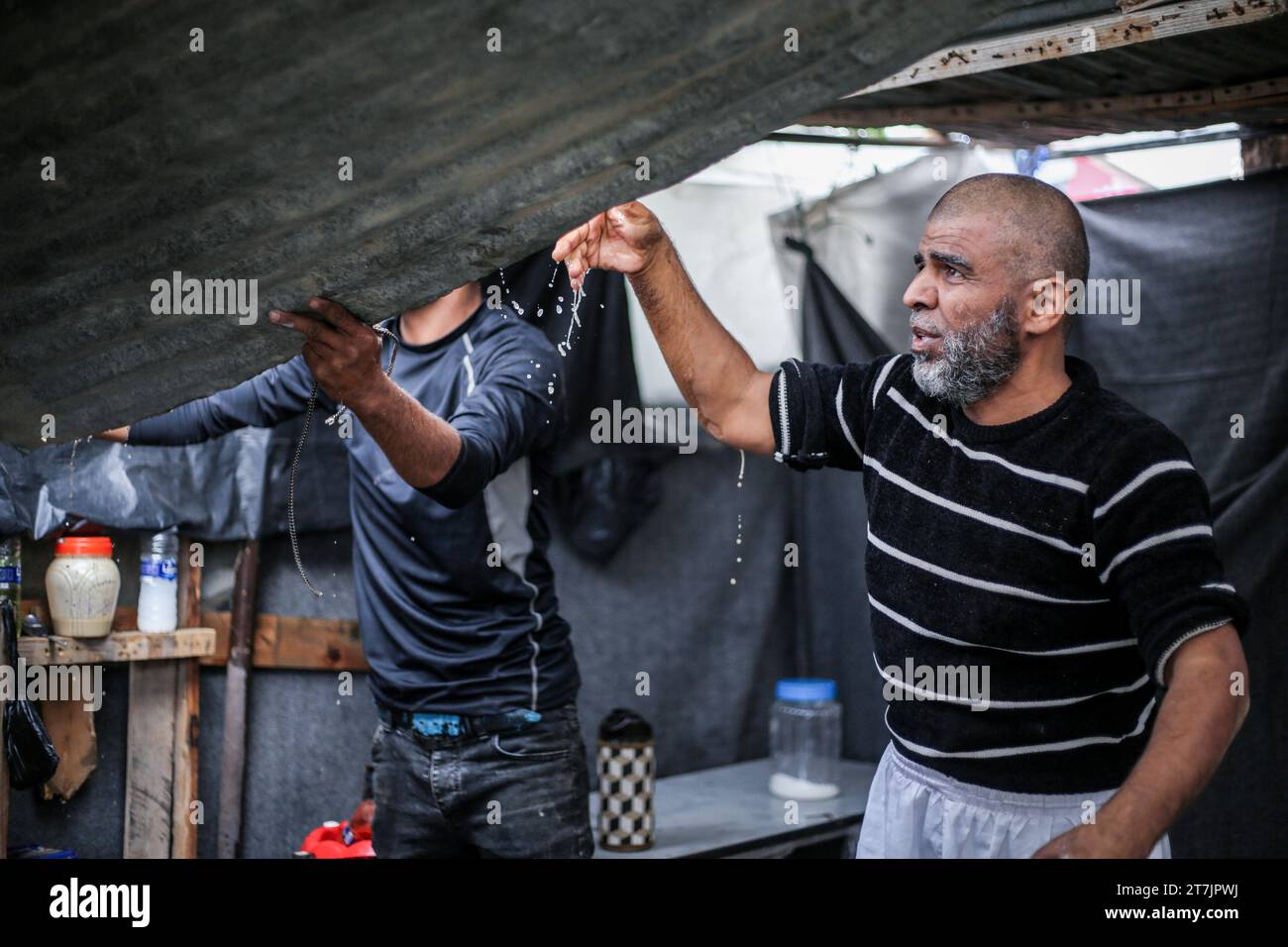 Gaza, Palestine. 15 novembre 2023. Un palestinien tente de ranger les ...