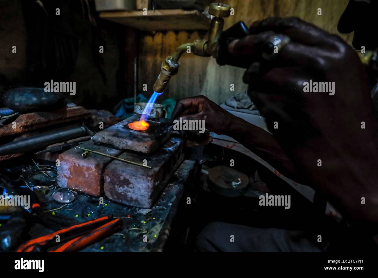 Samwel Mwangi makes jewelries at his shop in Kibera Slum on October 25, 2023 in Nairobi, Kenya ...