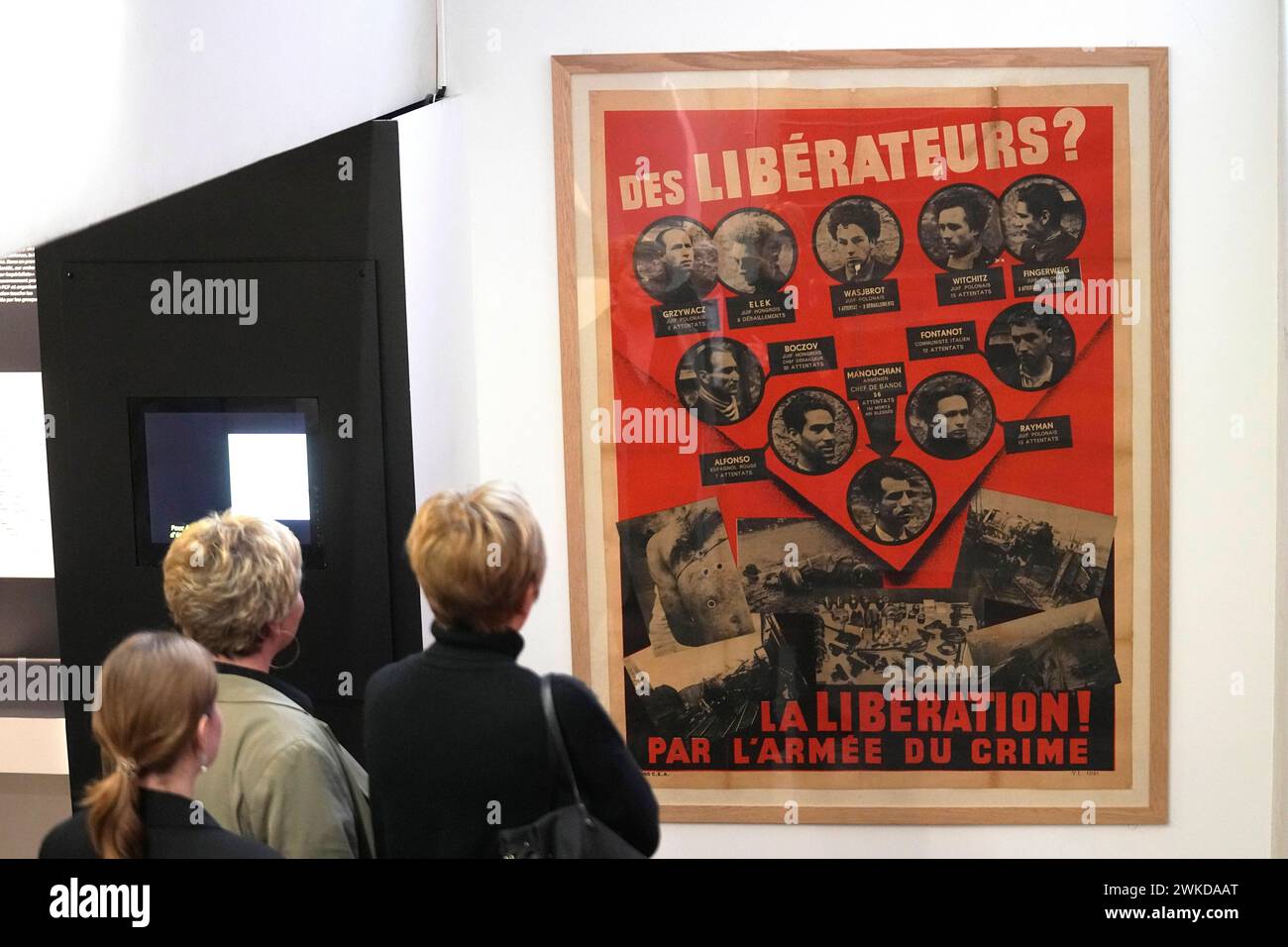 Visitors watch the nazi propaganda poster of Missak Manouchian and his ...