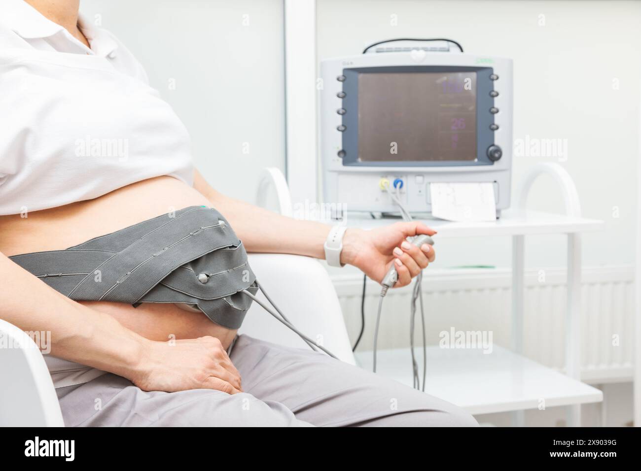 Une femme enceinte effectuant une cardiotocographie (CTG) pour ...