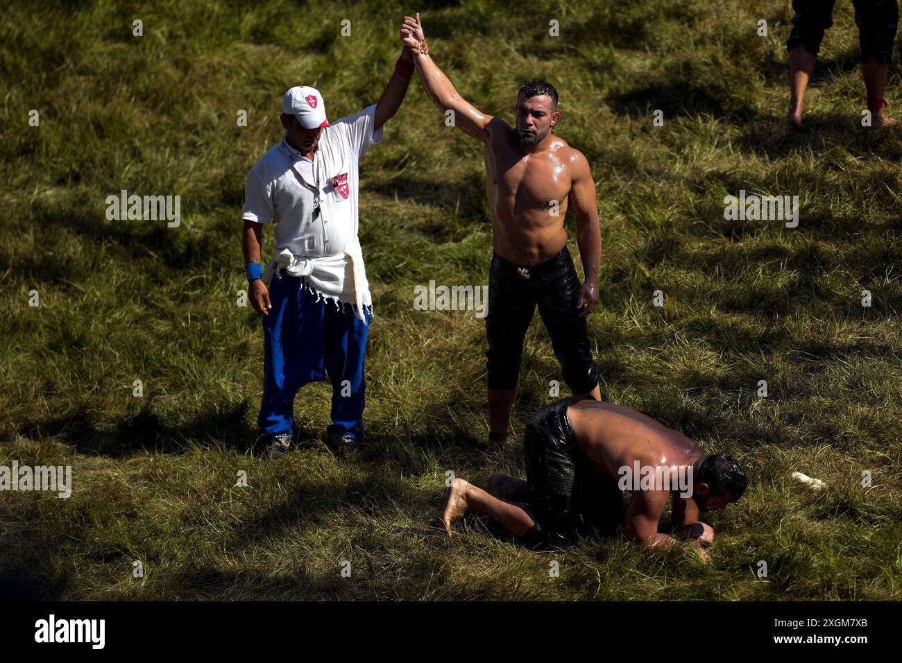 A referee announces the victory of a wrestler in a round during the ...