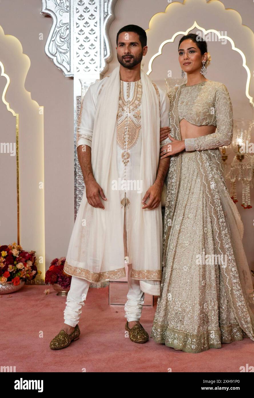 Indian actor Shahid Kapoor poses for a photograph with his wife Mira ...