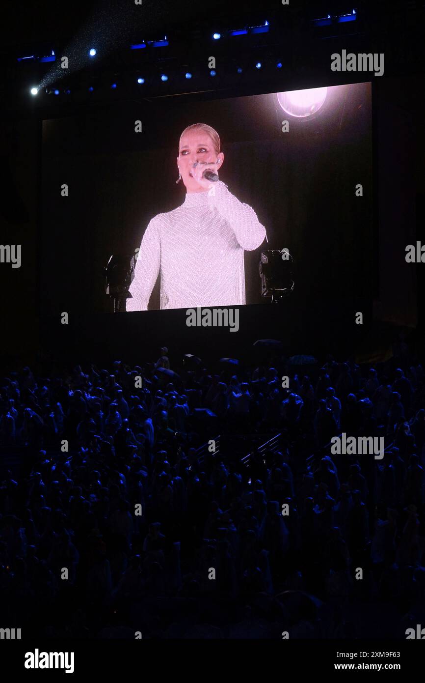 Canadian Singer Celine Dion performs on the Eiffel Tower on the screen ...