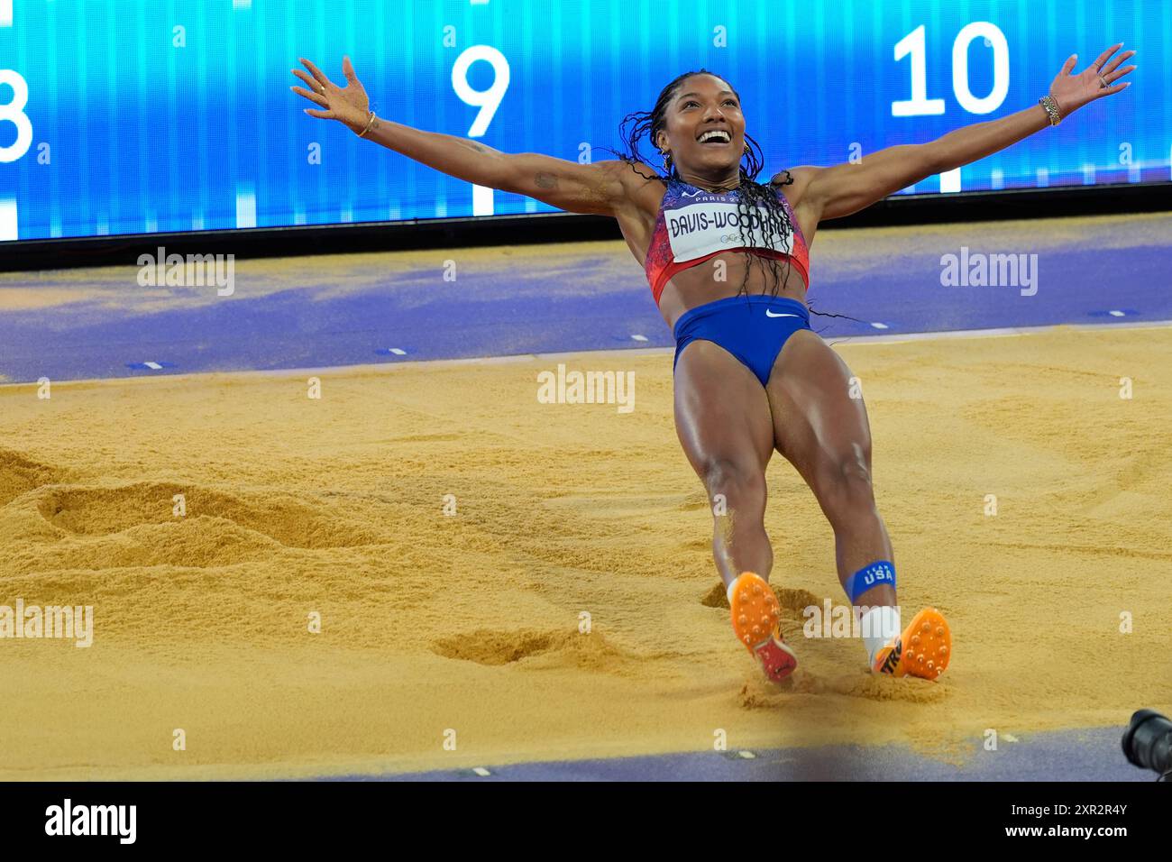 Tara Davis-Woodhall, of the United States, falls backwards into the pit ...