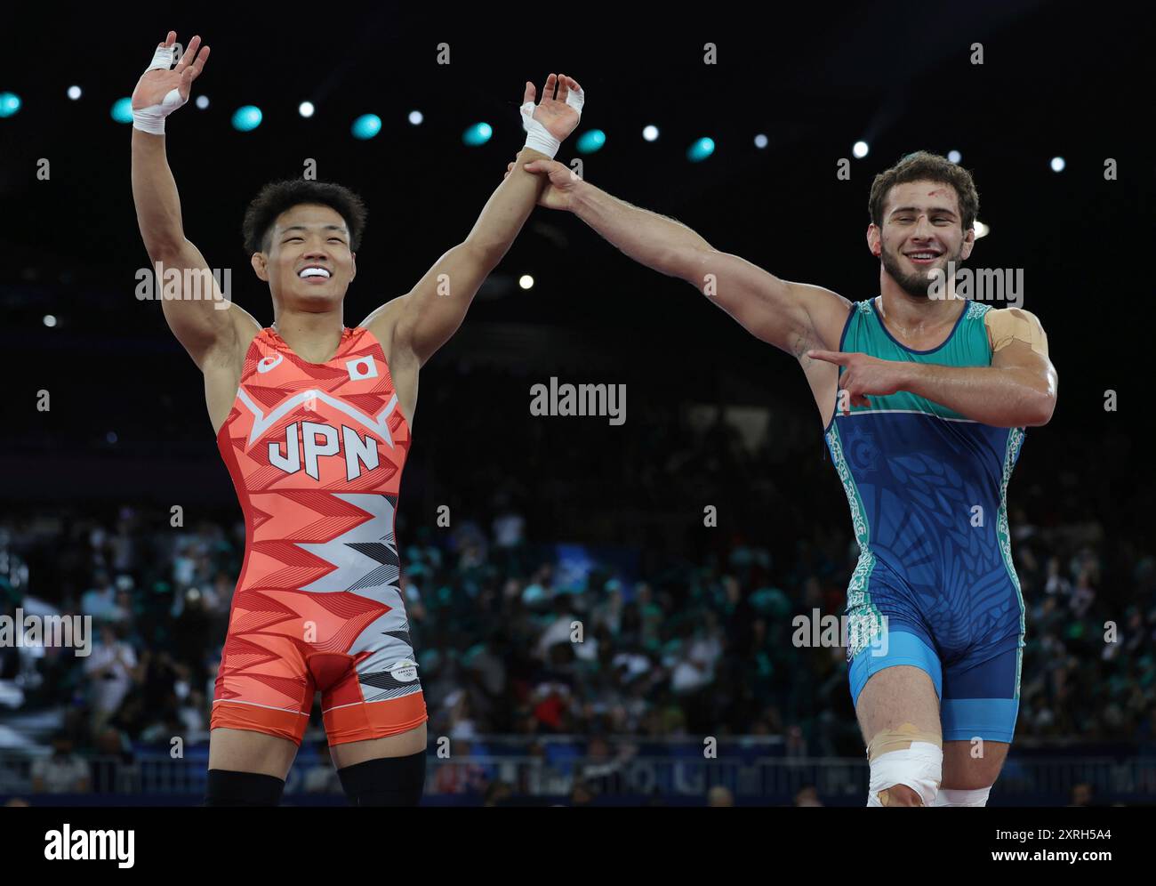 JAMALOV Razambek Salambekovitch (blue) of Uzbekistan and Japan's TAKATANI Daichi (red) praise ...