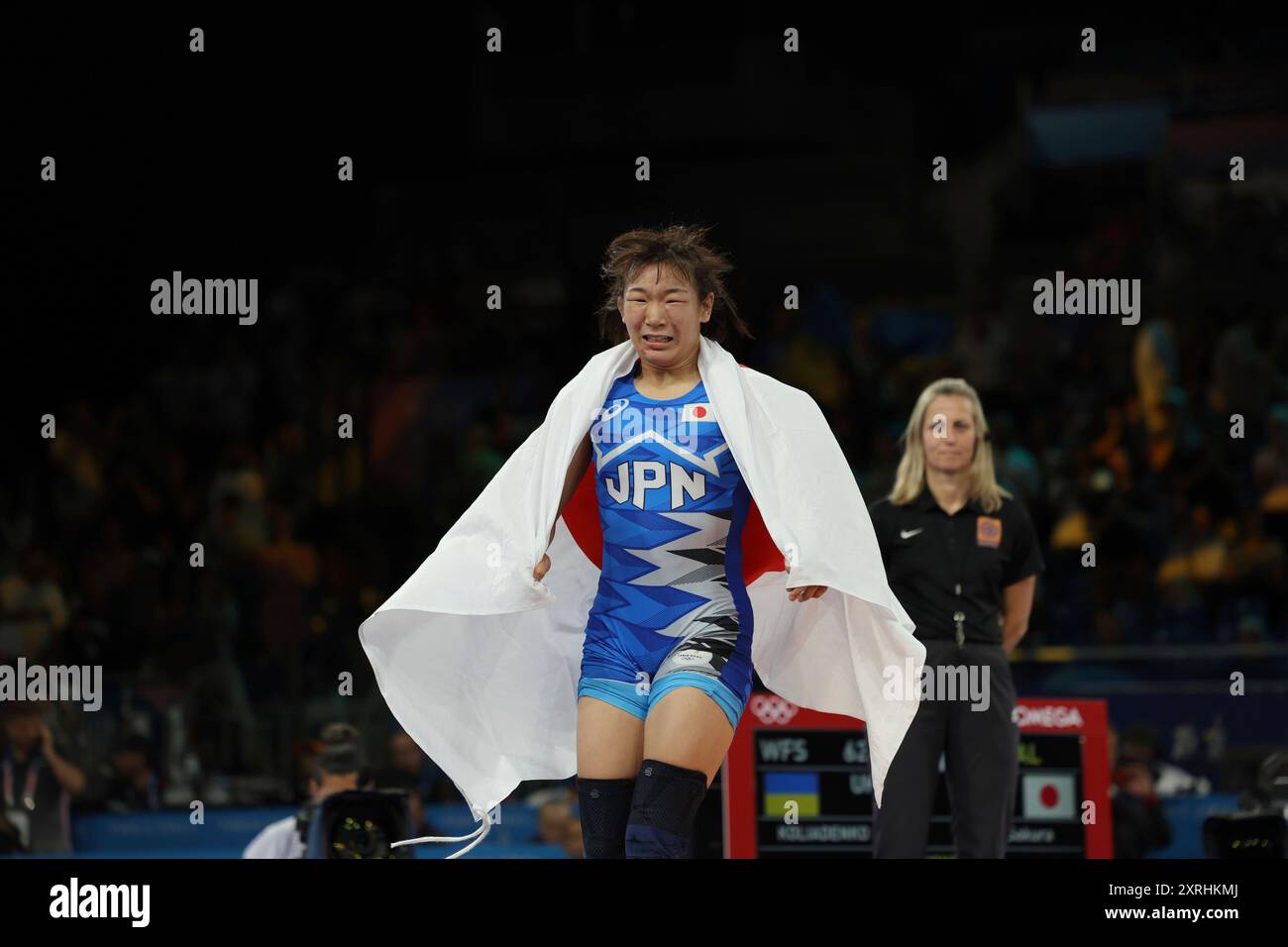 Japan's MOTOKI Sakura, wrapped in a Japanese national flag, celebrates ...