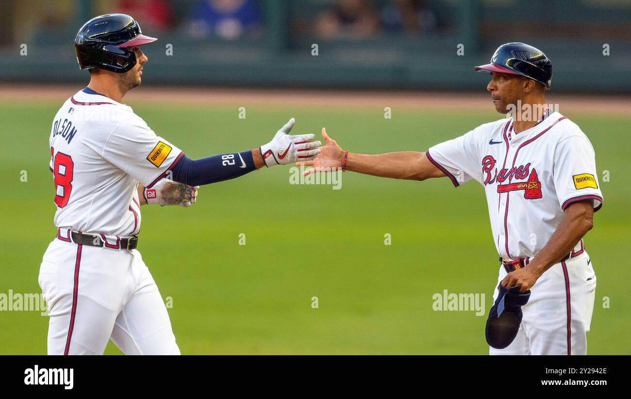 Atlanta Braves' Matt Olson, left, is congratulated by first base coach ...