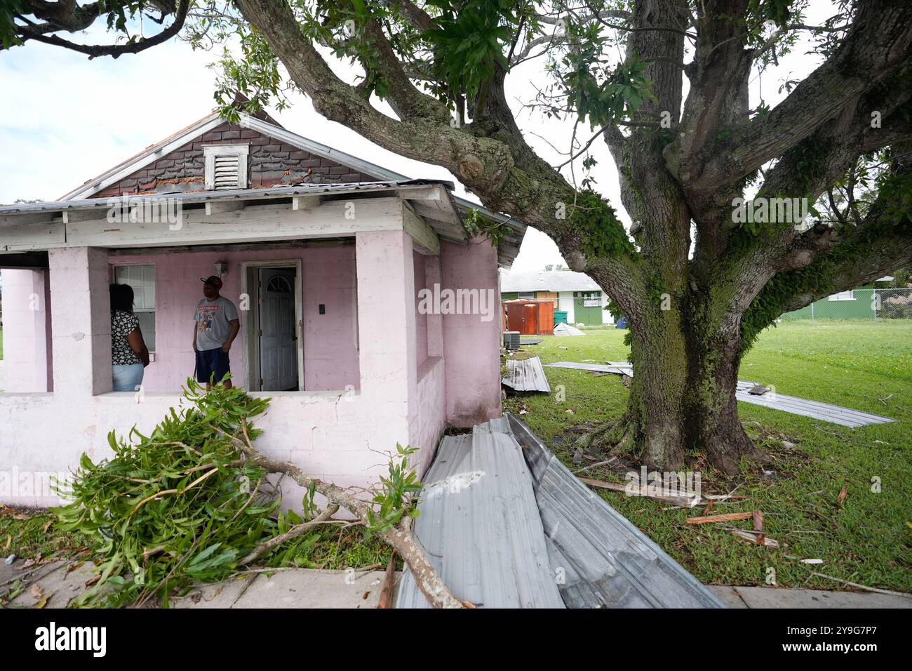 Terry E. Ducre Jr. and his wife Natasha stand on the porch of their ...